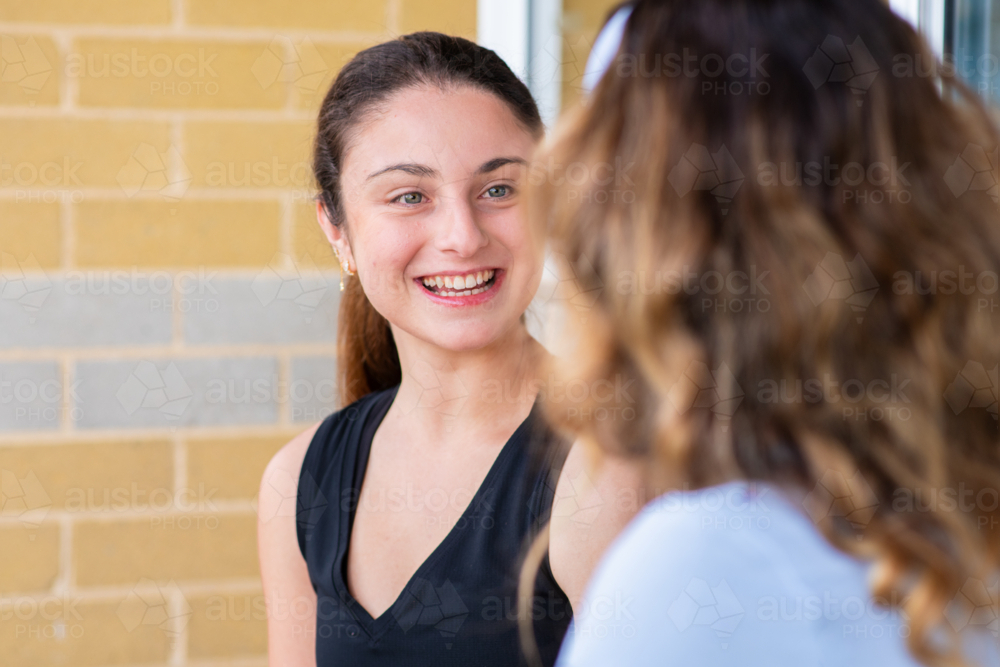 Image of two young women talking - Austockphoto