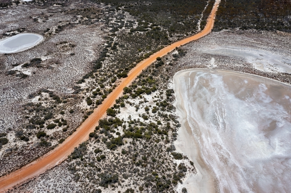 Image of Unsealed road winds between salt lakes in western australia ...