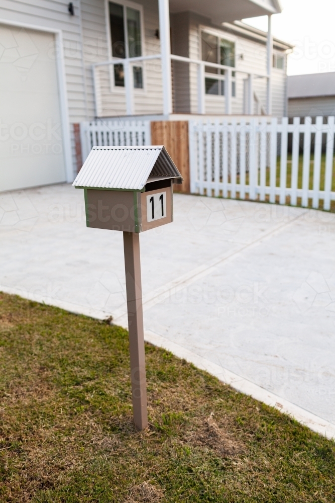 Image of Urban mailbox with number 11 in front of new house - Austockphoto