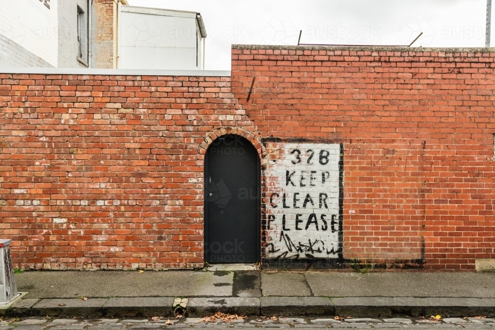 Image of urban street scene with "please keep clear" sign - Austockphoto