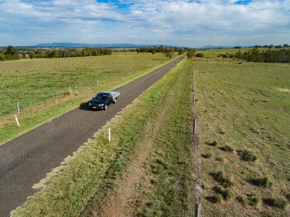 Image of Ute on unmarked rural road - Austockphoto