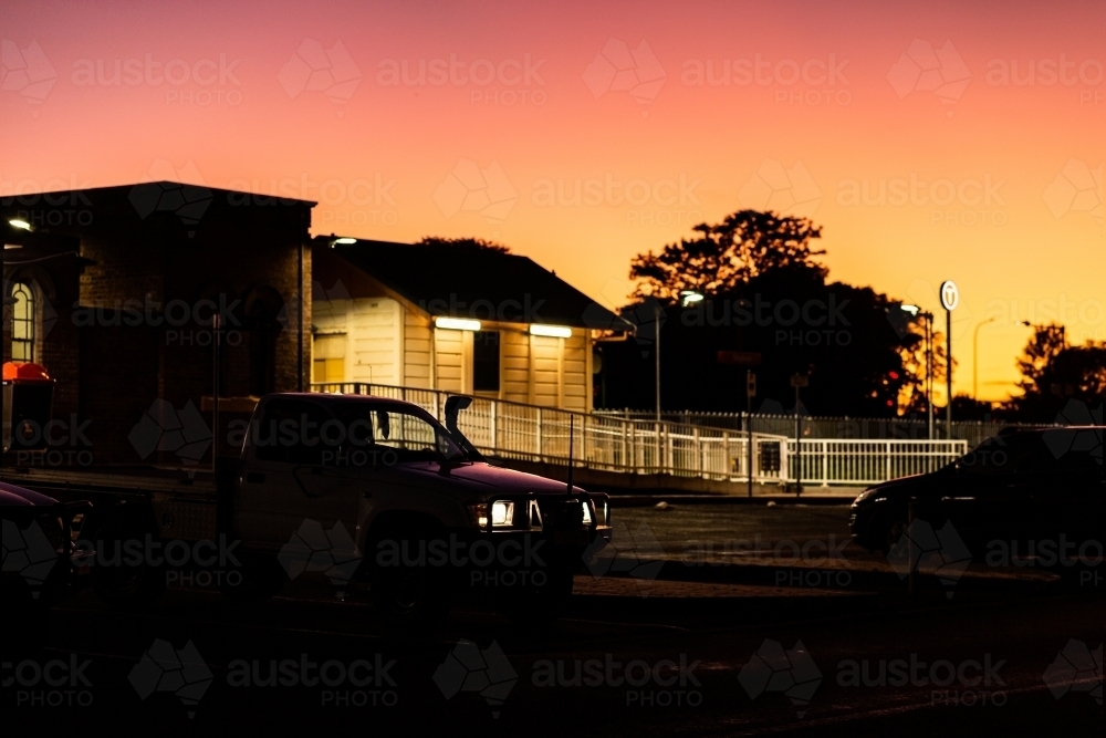 Image of Ute parked beside country train station at dusk - Austockphoto