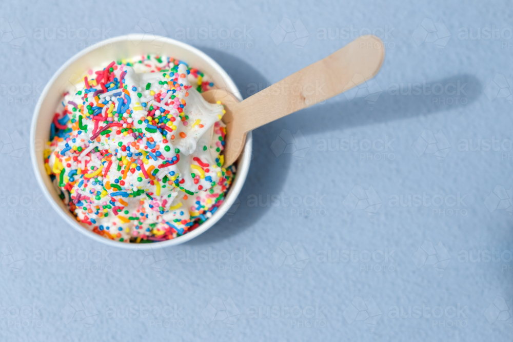Image of Vanilla soft serve icecream with colourful sprinkles in tub ...