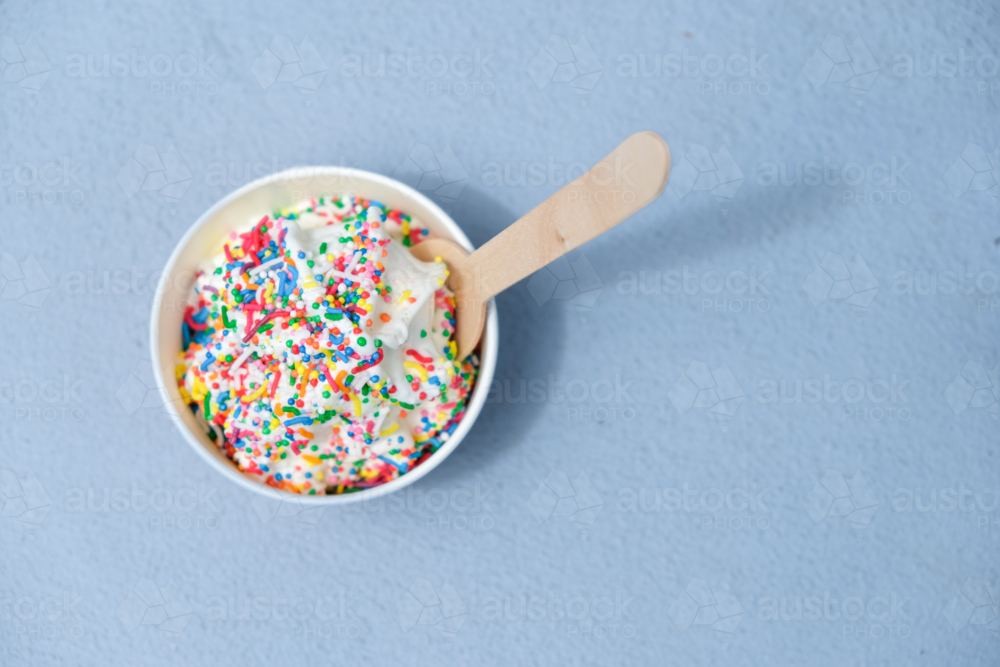 Image of Vanilla soft serve icecream with colourful sprinkles in tub ...