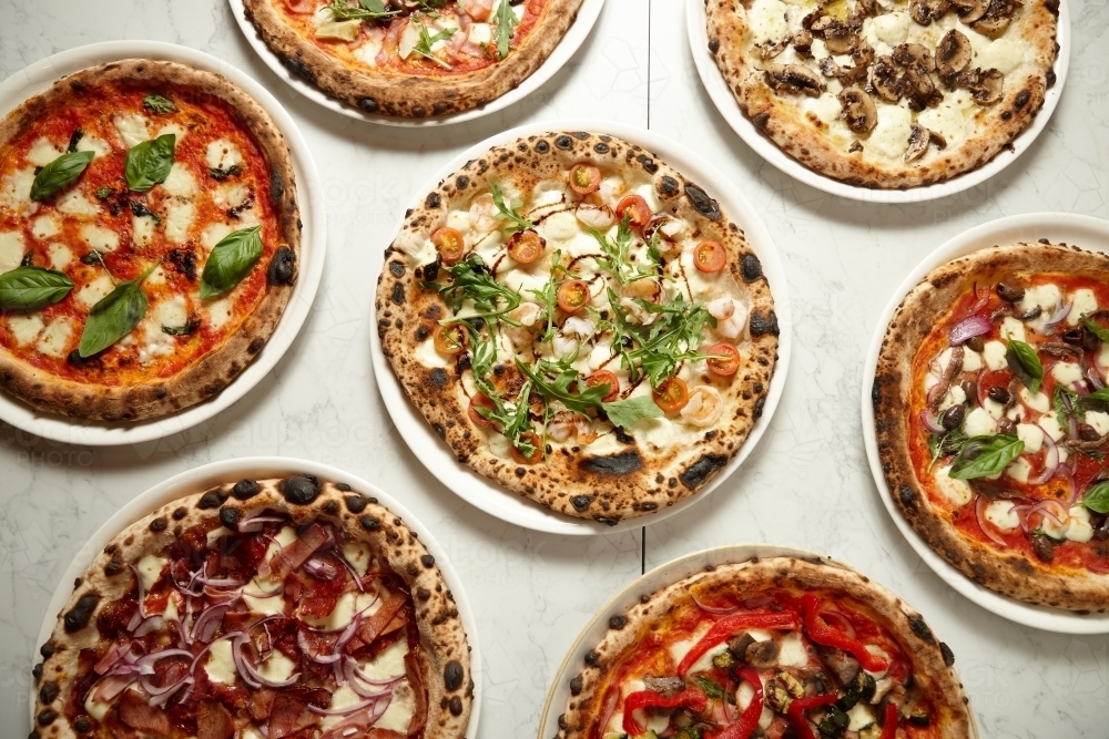 Image of various kinds of california style pizza - Austockphoto