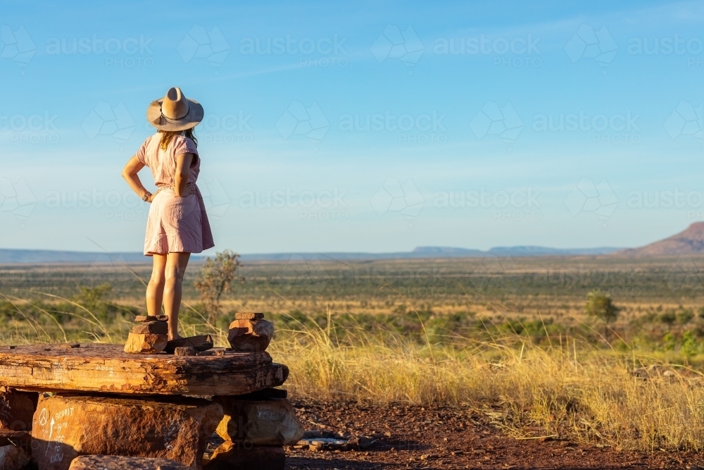 Image of vast Kimberley landscape with tourist in felt hat - Austockphoto
