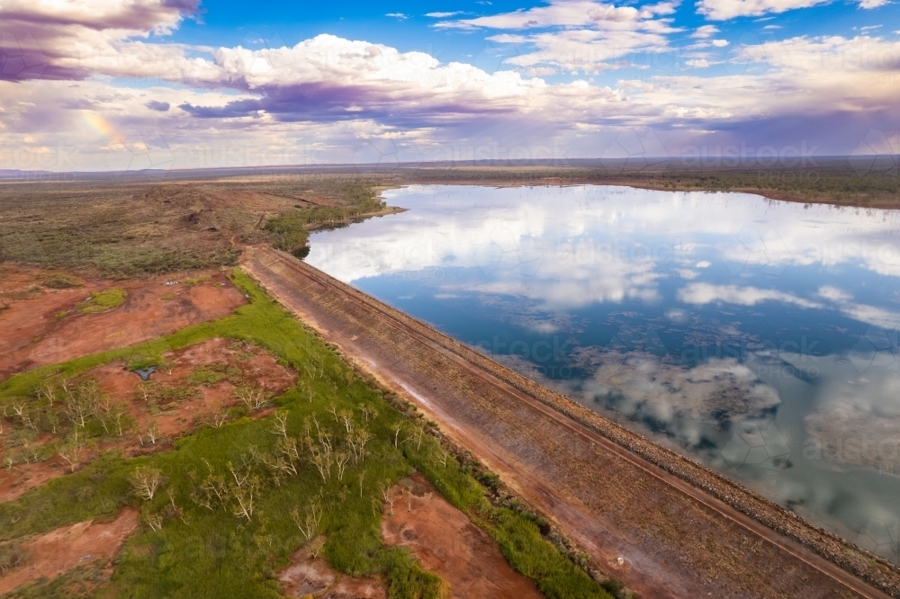 Image of Vast rural landscape with reflective lake - Austockphoto