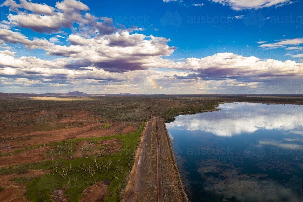 Image of Vast rural landscape with reflective lake - Austockphoto