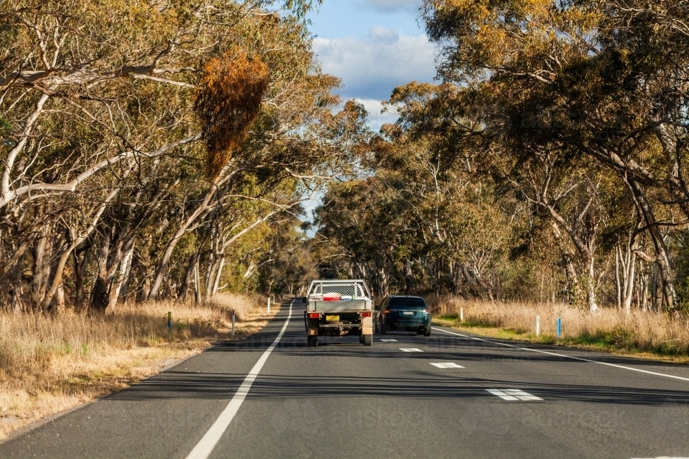 Image of Vehicle overtaking ute on dotted lines on rural highway road ...