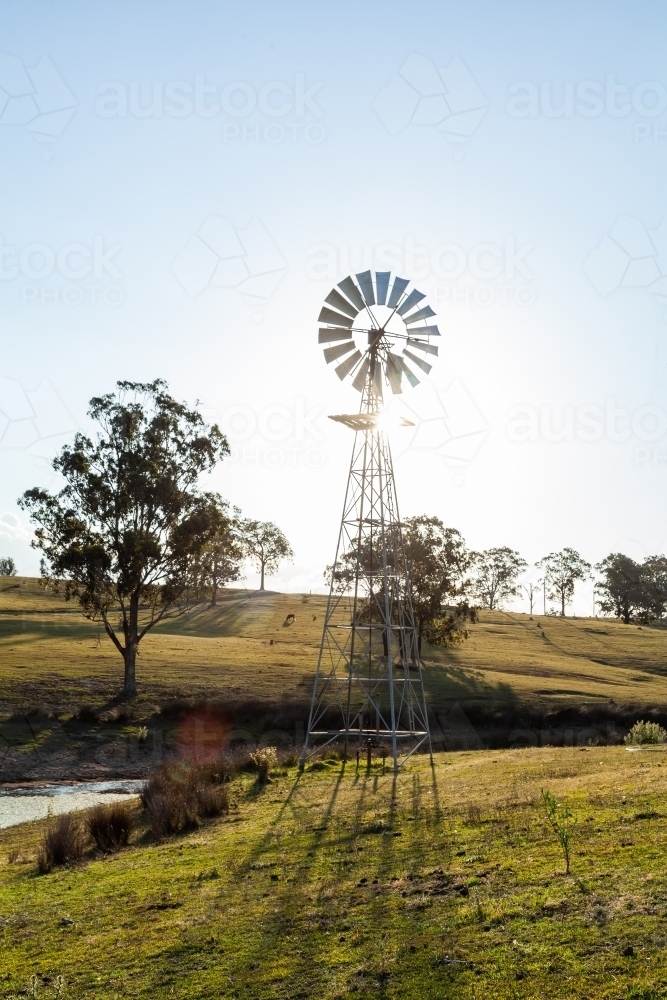 Image of Vertical windmill in paddock on country farm - Austockphoto