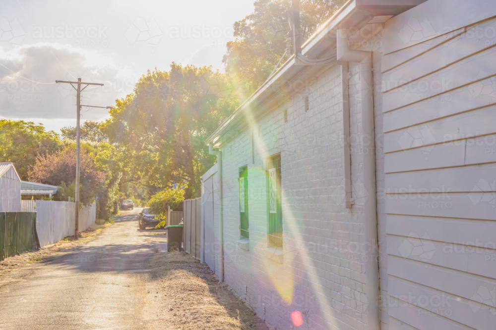 Image of Vibrant afternoon light illuminating urban alleyway - Austockphoto