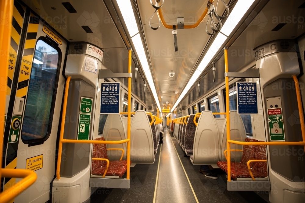 Image of view down the aisle of a passenger train - Austockphoto
