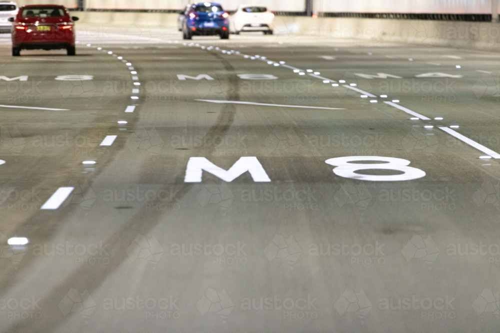 Image of blurred view from a car, Sydney toll road tunnel showing M8 ...