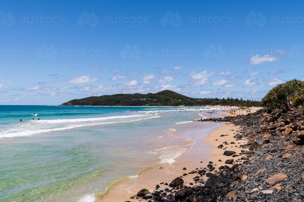Image of View of Cape Byron and lighthouse from the beach at Byron Bay ...