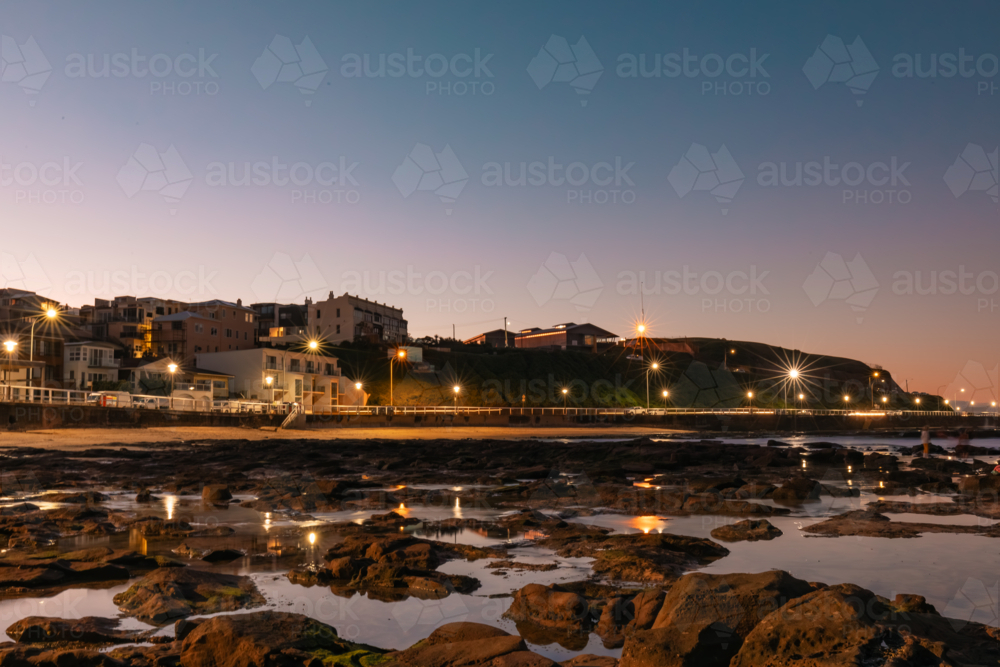 Image of View of Newcastle city at night over rock pools at low tide ...