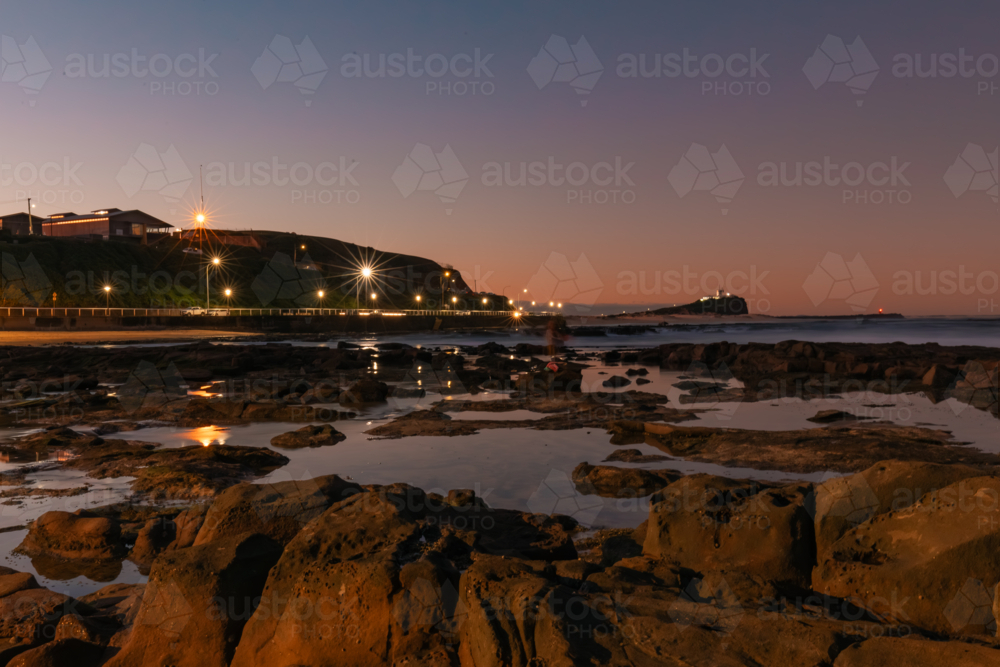 Image of View of Newcastle city at night over rock pools at low tide ...