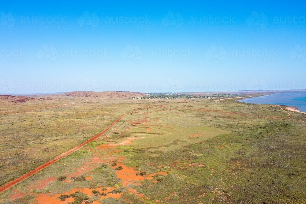 Image of view over coastal landscape with Karratha in the distance ...