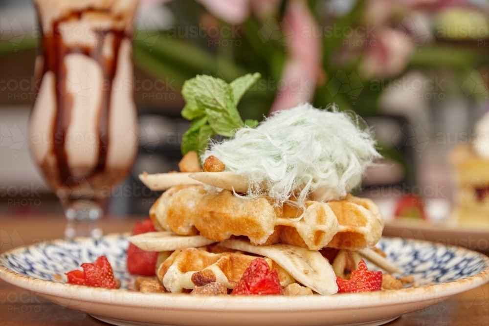 Image of Waffle dessert with chocolate milkshake on table - Austockphoto
