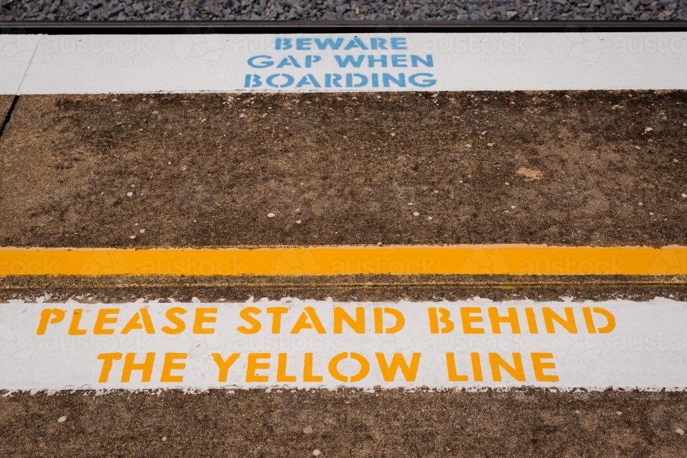 Image of Warning sign to "Beware gap" and 'Stand behind the yellow line ...