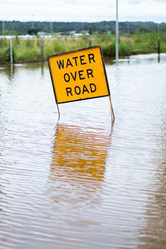 Image of Water over road sign in floodwaters - Austockphoto