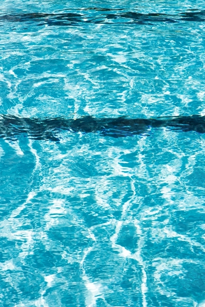 Image of Water ripples in a swimming pool with no people - Austockphoto