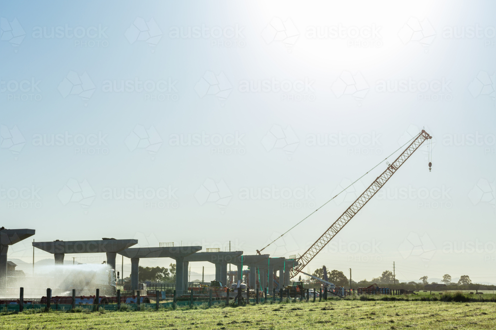 Image of Water spraying truck dampening down ground to minimize dust on ...