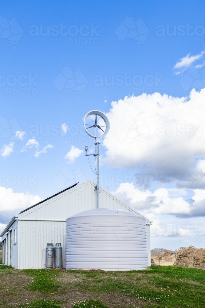 Image of Water tank and shed with mini wind turbine power generator ...