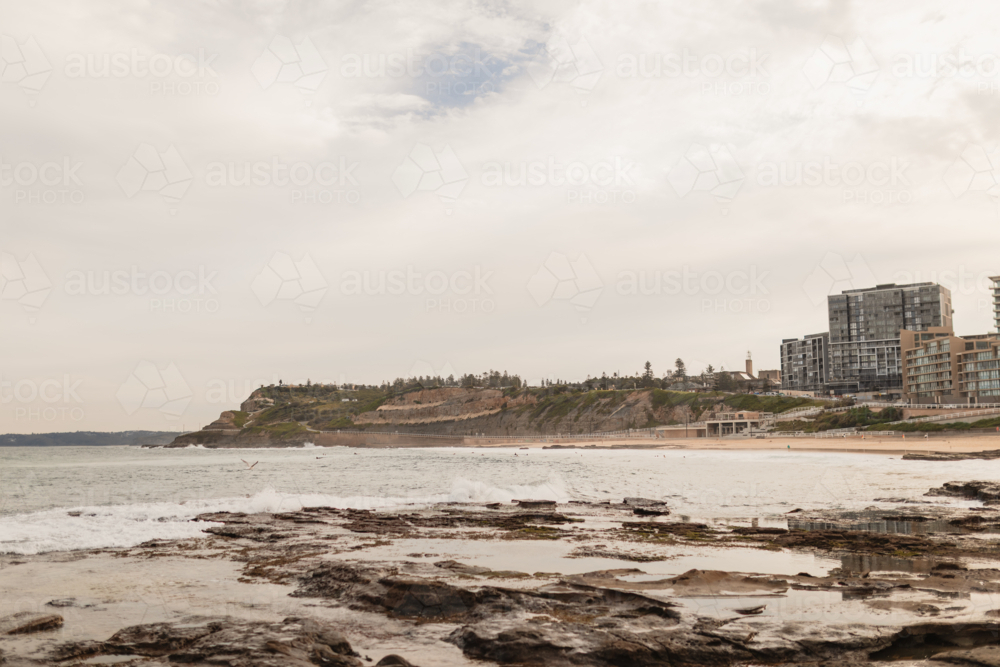 Image of Waves breaking on rocks at Newcastle Beach - Austockphoto