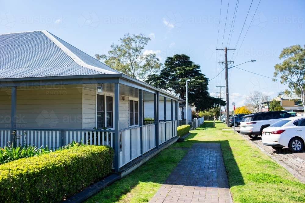 Image of Weatherboard home with veranda alongside street in country ...