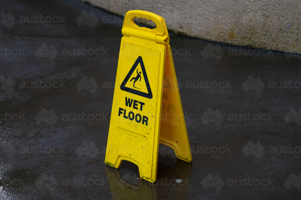 Image of wet floor caution sign - Austockphoto