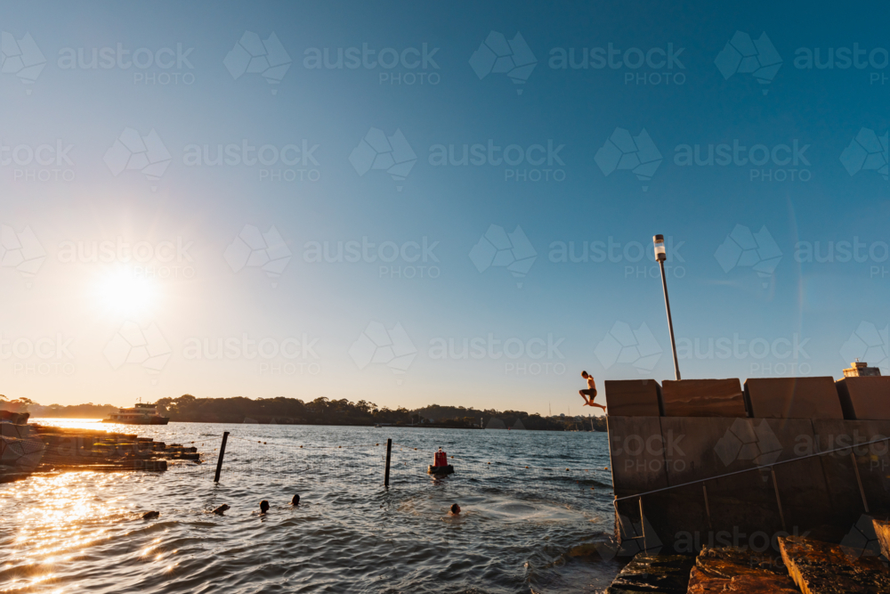 Image of Wet kids jumping from ledge into water at Marrinawi Cove in ...