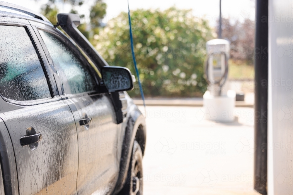 Image of Wet vehicle covered in suds in self-service car wash bay ...
