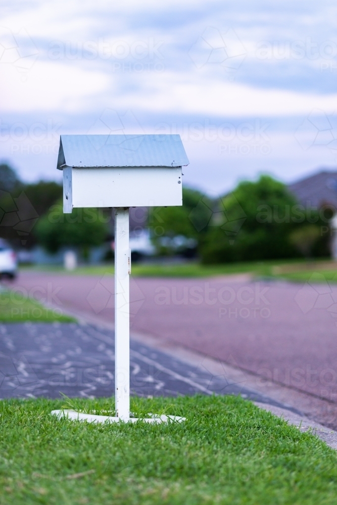 Image of White and blue mailbox beside driveway of house in suburban ...