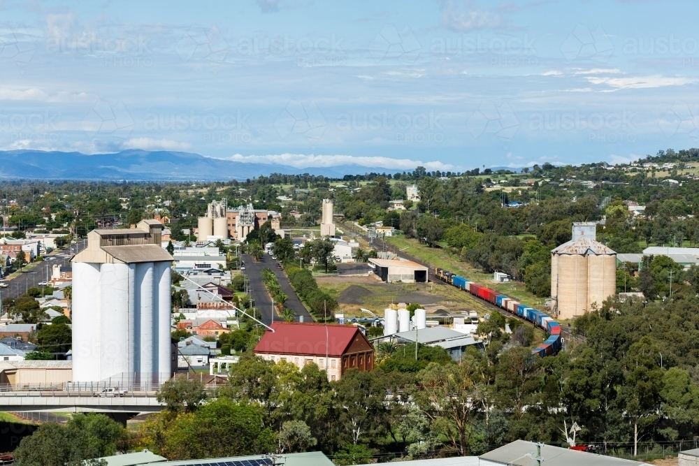 Image of White silos in town of Gunnedah with freight train passing on ...