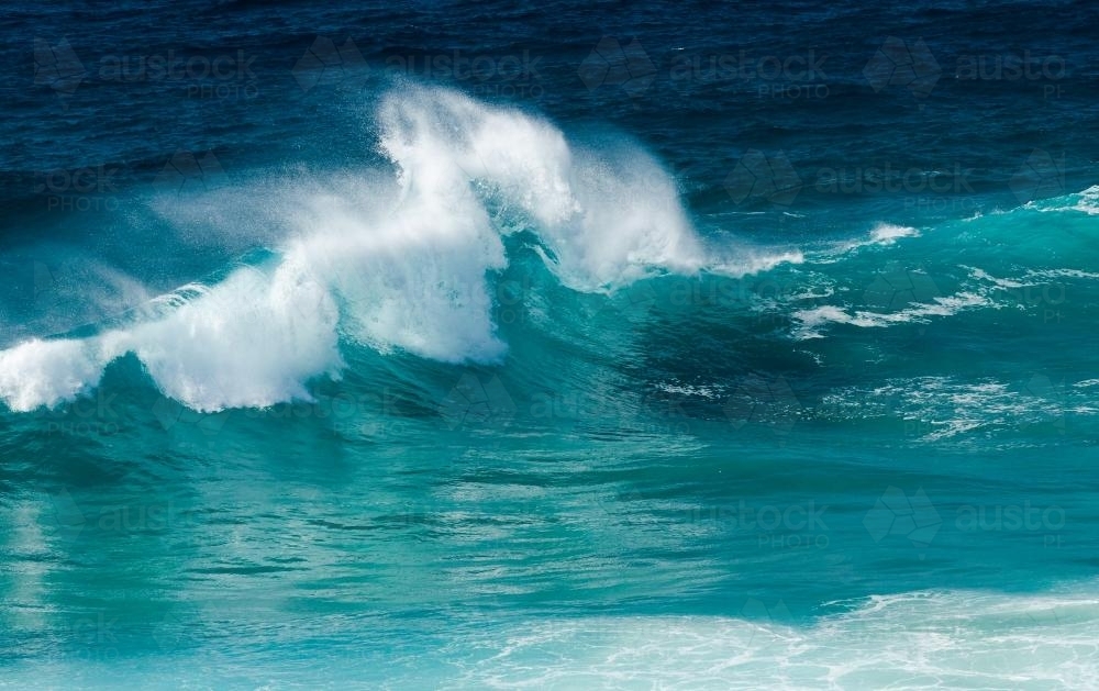 Image of Wind blowing the top off a wave - Austockphoto