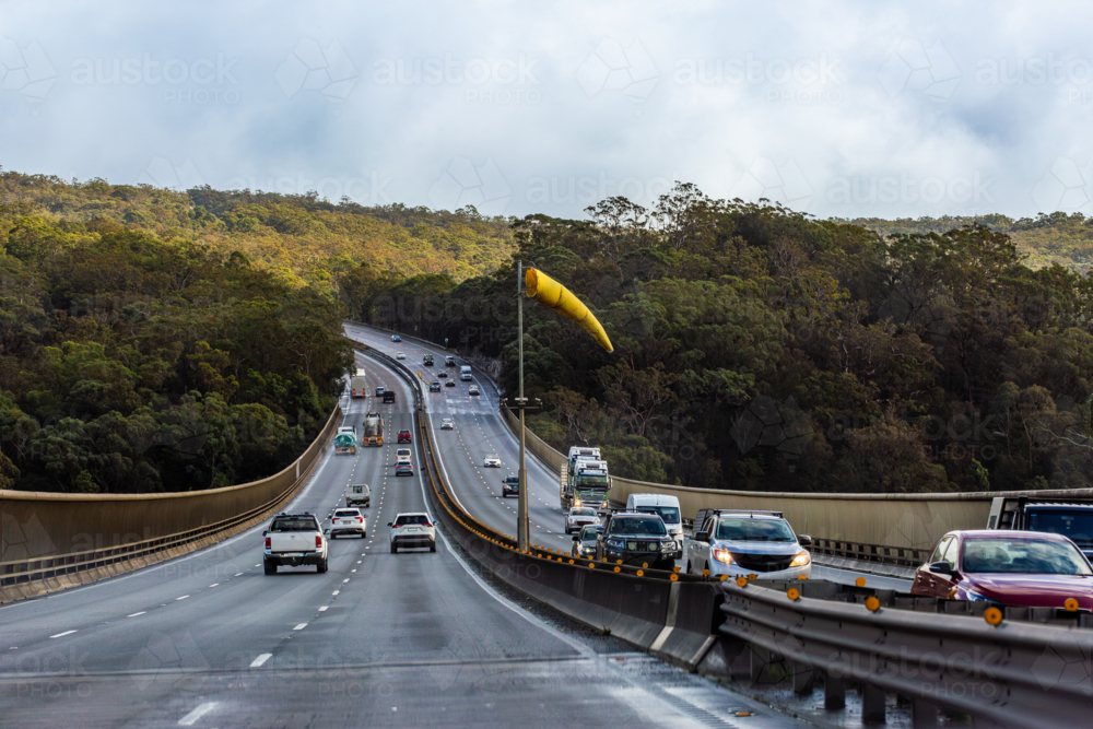 Image of wind sock above highway road bridge crossing river in national ...