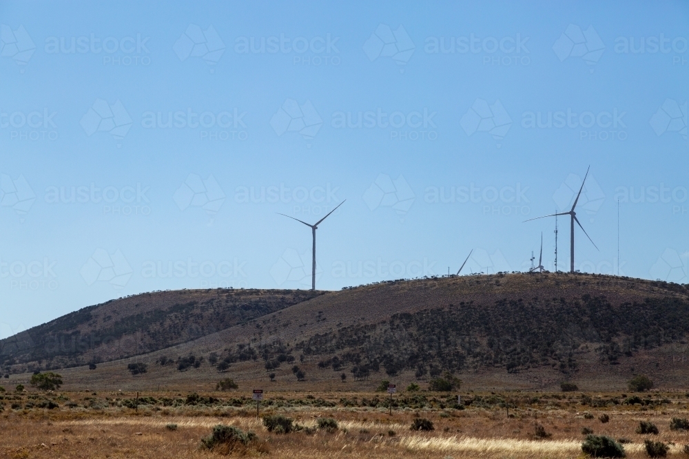 Image of Wind turbines along ridge line at a wind farm. - Austockphoto