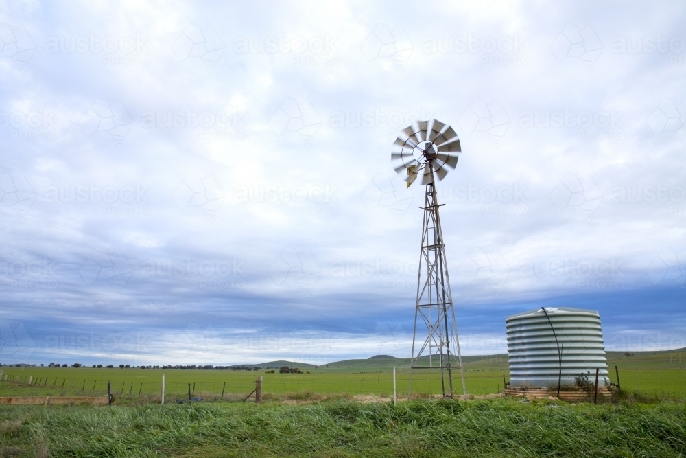 Image of Windmill and tank on right - Austockphoto