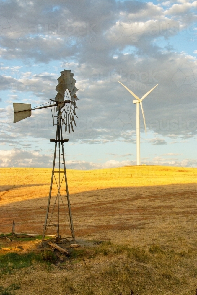 Image of Windmill in front with wind turbine in the background ...