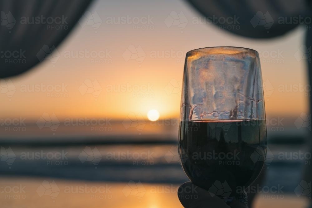 Image of wine glass at sunset - Austockphoto