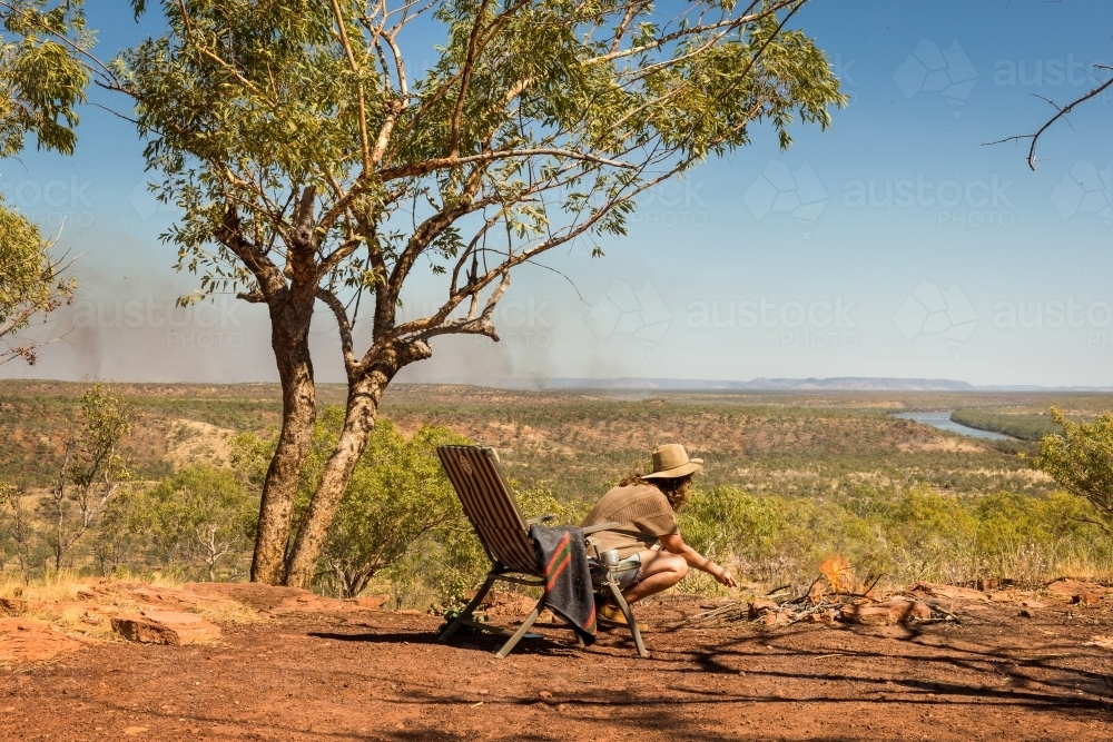 Image of woman camping in the outback - Austockphoto
