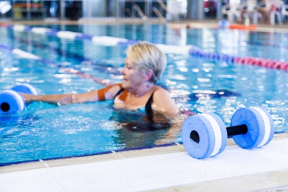 Image of Woman doing hydrotherapy exercises in local town pool ...
