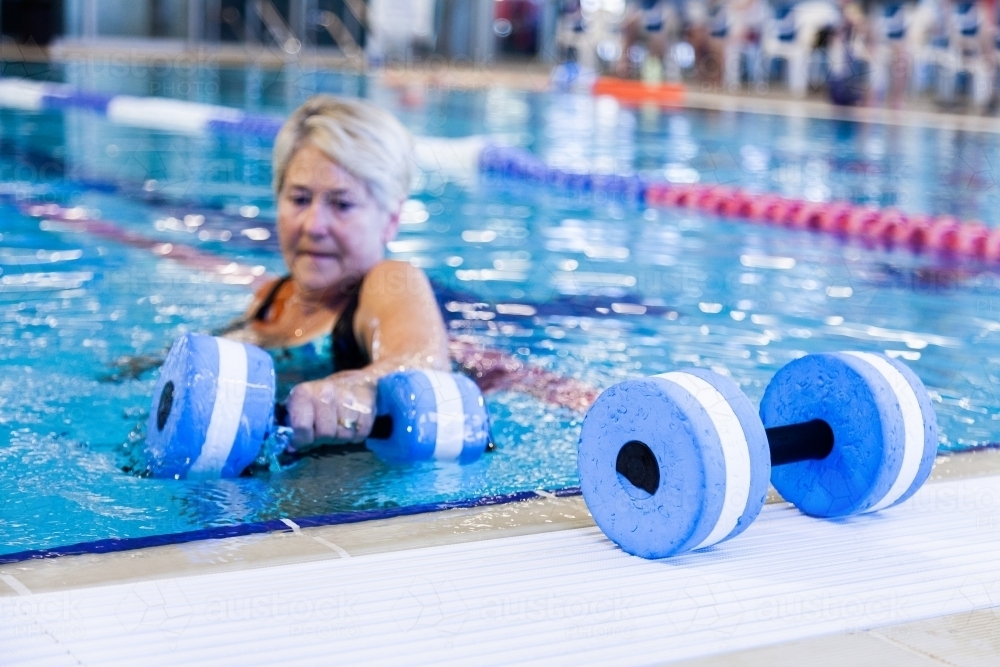 Image of Woman doing hydrotherapy exercises in local town pool ...