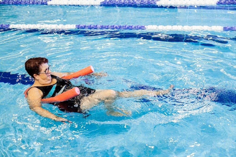 Image of Woman doing hydrotherapy exercises in local town pool ...