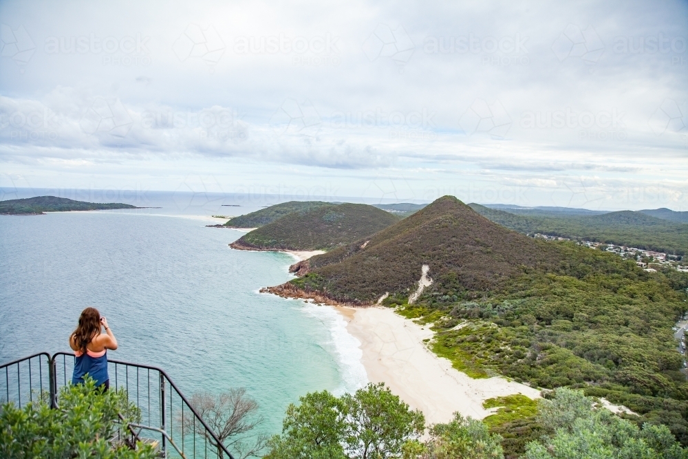 Image of Woman looking out from Tomaree Head Summit walk taking photos ...