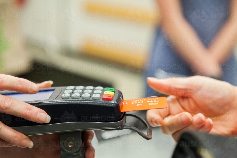 Image of Woman paying for shopping with visa debit card at supermarket ...
