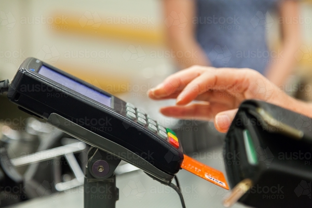 Image of Woman paying for shopping with visa debit card at supermarket ...