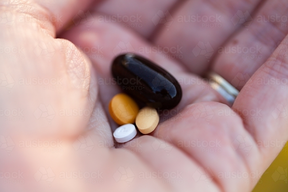 Image of woman's hand holding pregnancy tablets - Austockphoto