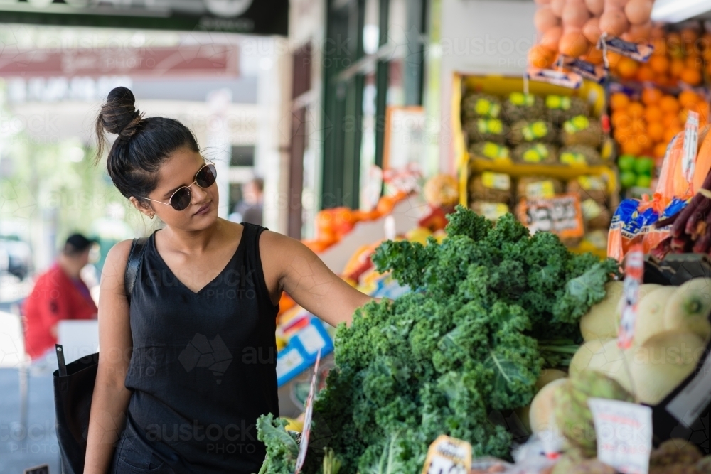 Image of woman shopping at local fruit shop - Austockphoto