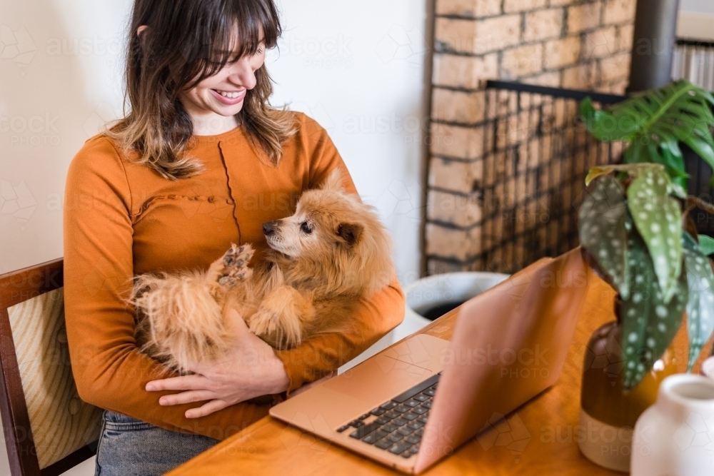 Image of woman using computer at home - Austockphoto